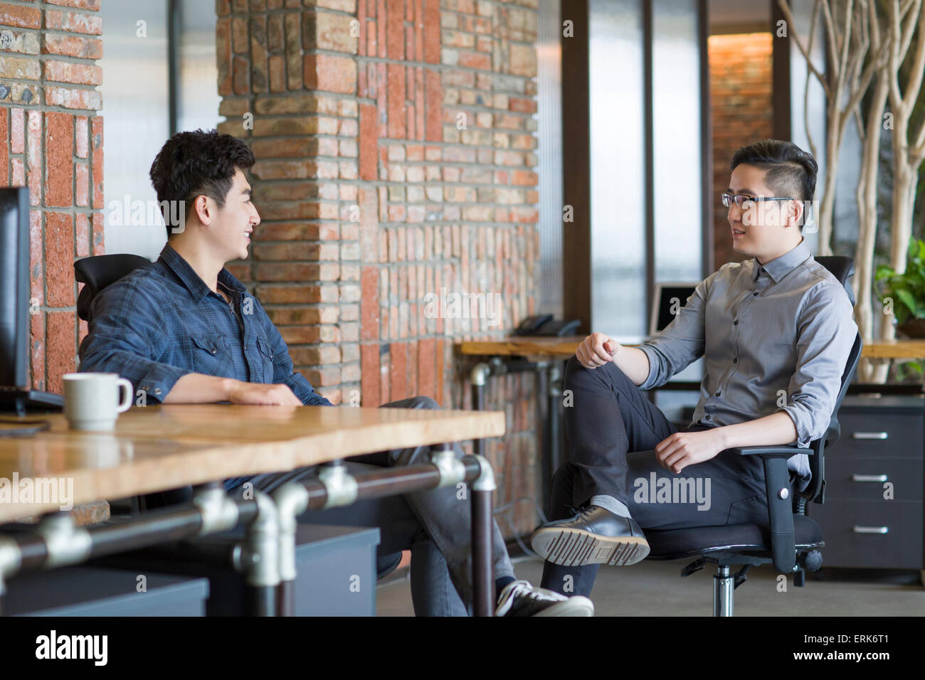 IT workers talking in office Stock Photo - Alamy
