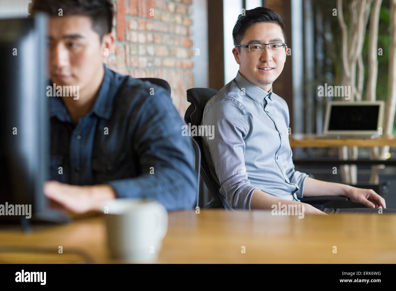 IT workers sitting in office Stock Photo - Alamy