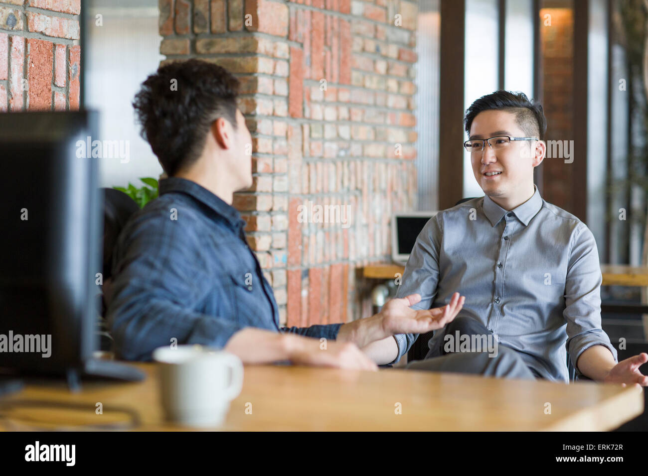 IT workers talking in office Stock Photo - Alamy