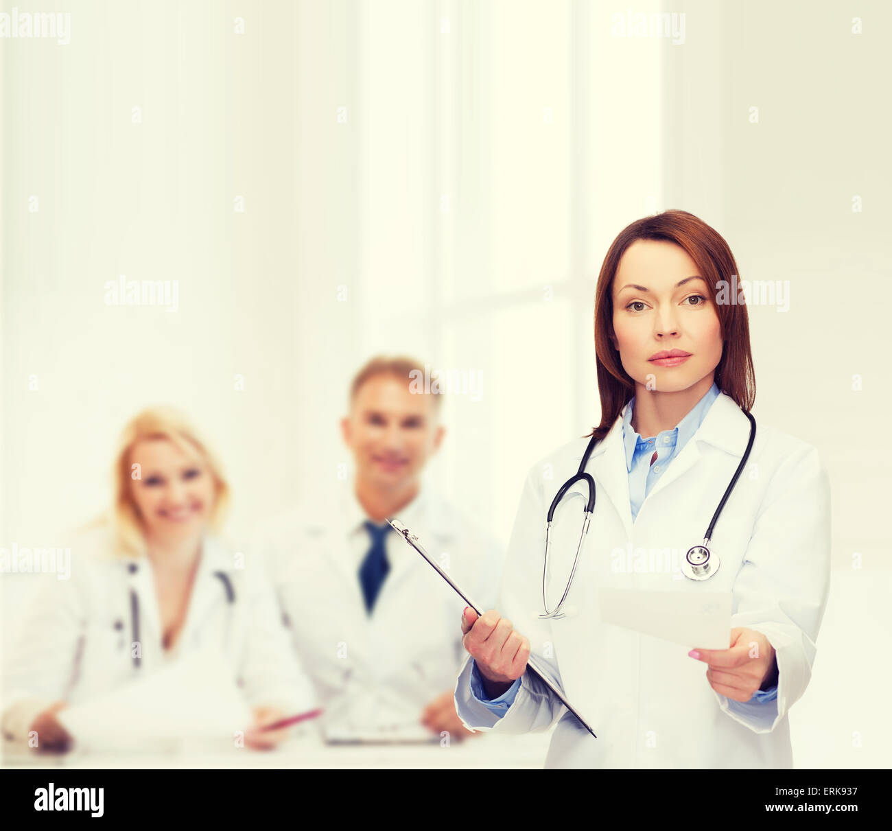 calm female doctor with clipboard Stock Photo - Alamy