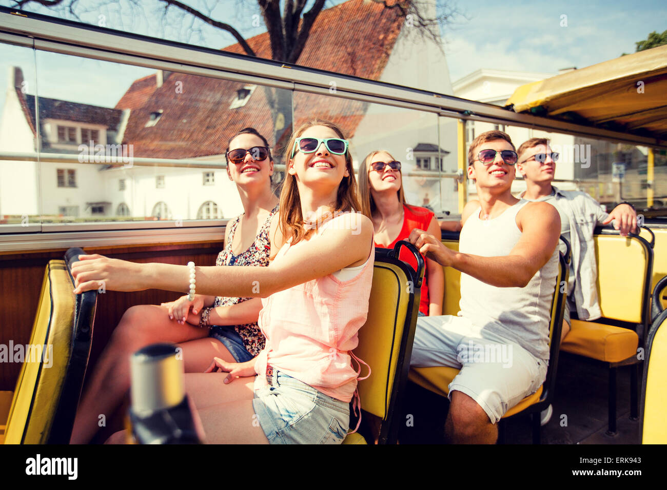 group of smiling friends traveling by tour bus Stock Photo - Alamy