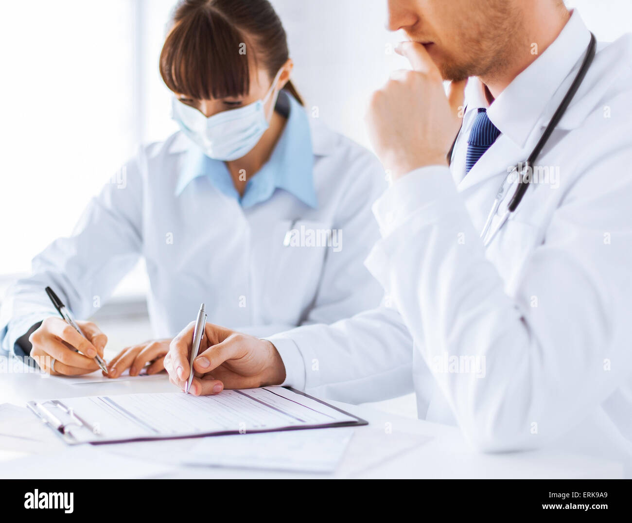 doctor and nurse writing prescription paper Stock Photo - Alamy