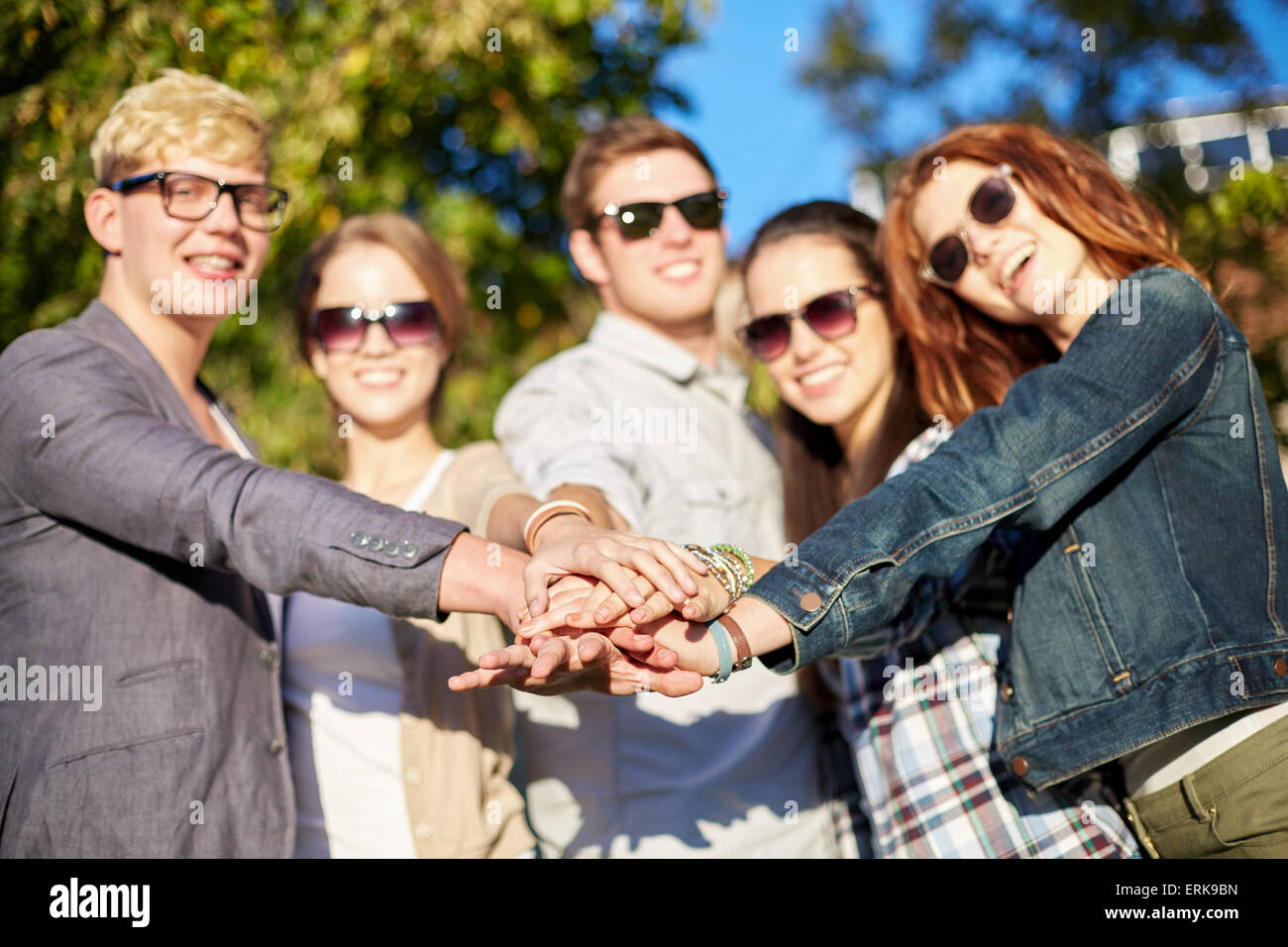 close up of teenage friends with hands on top Stock Photo - Alamy