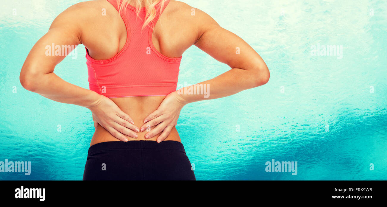 close up of sporty woman touching her back Stock Photo - Alamy