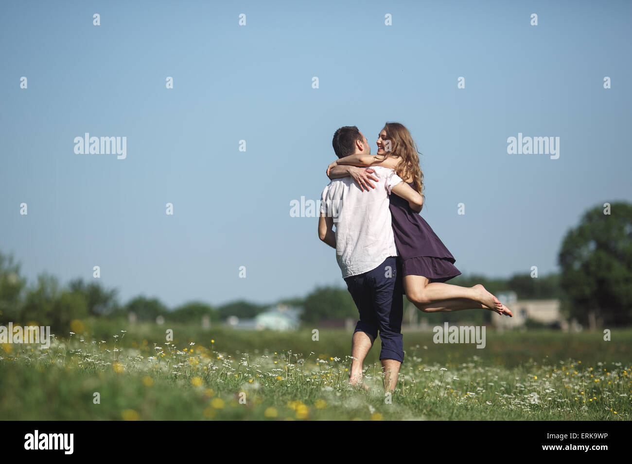 Couple running in field and have fun Stock Photo - Alamy