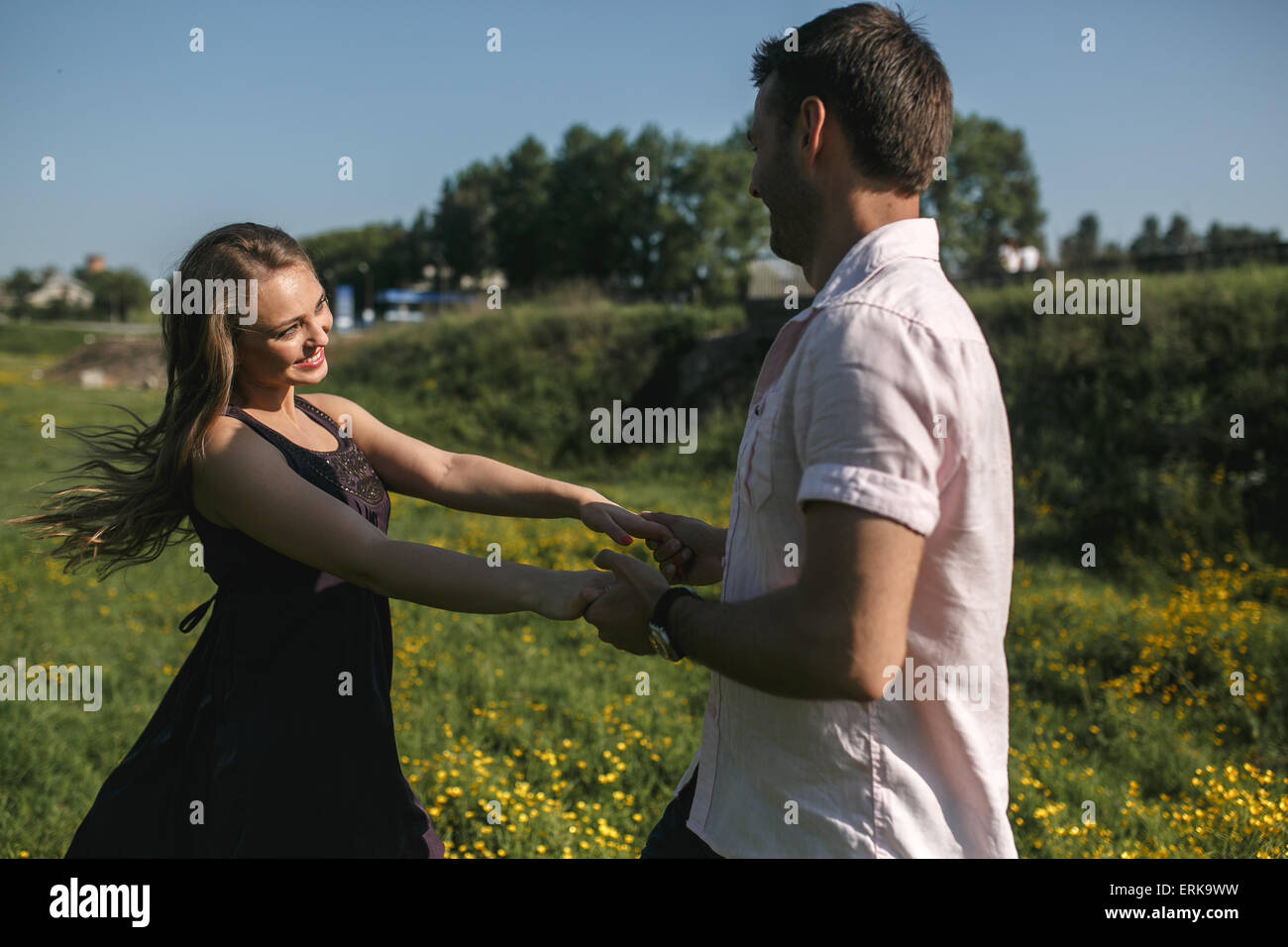Couple running in field and have fun Stock Photo - Alamy