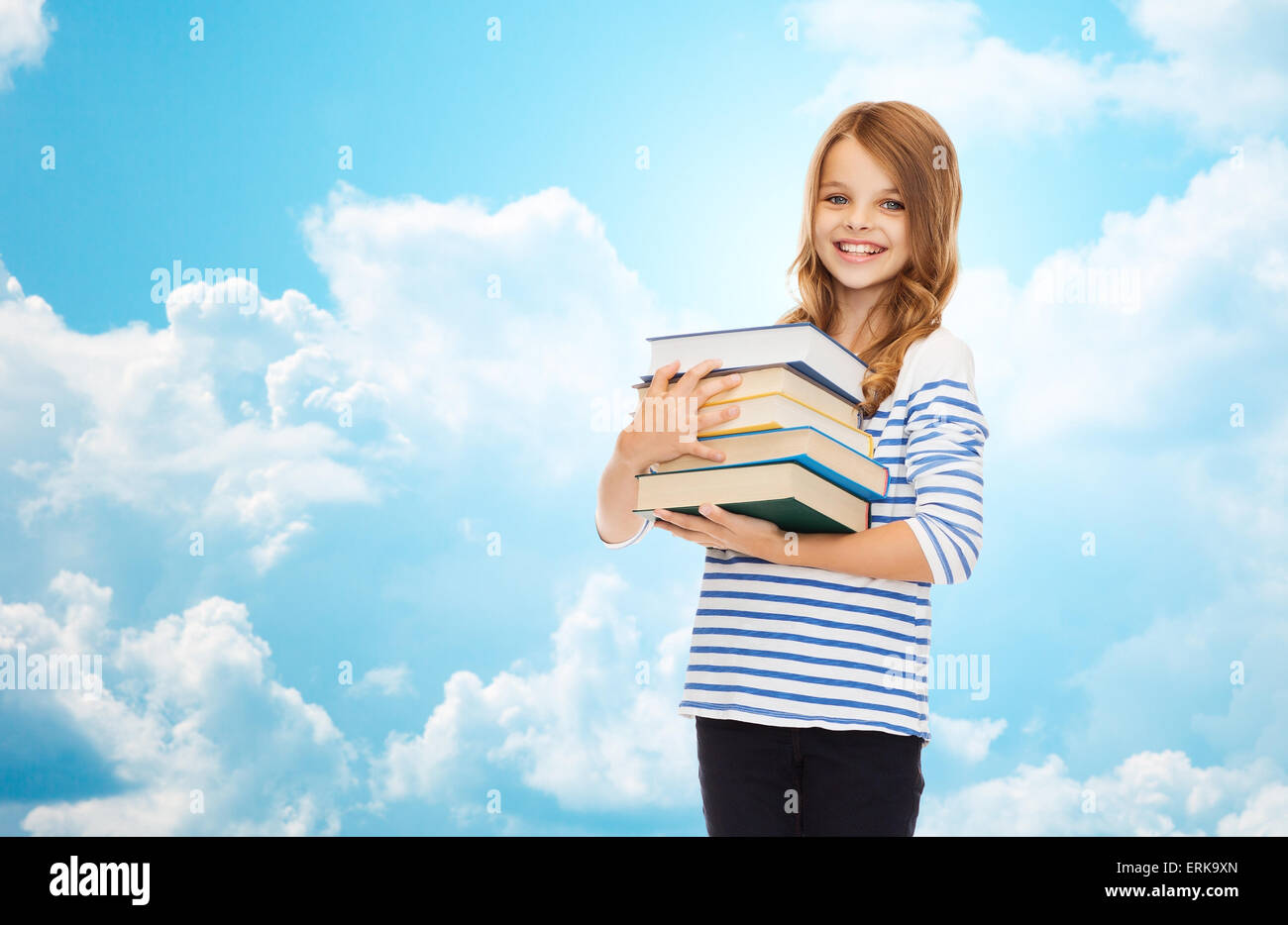 happy little student girl with many books Stock Photo - Alamy