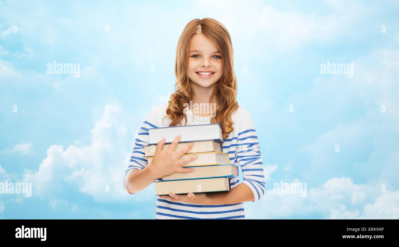happy little student girl with many books Stock Photo - Alamy