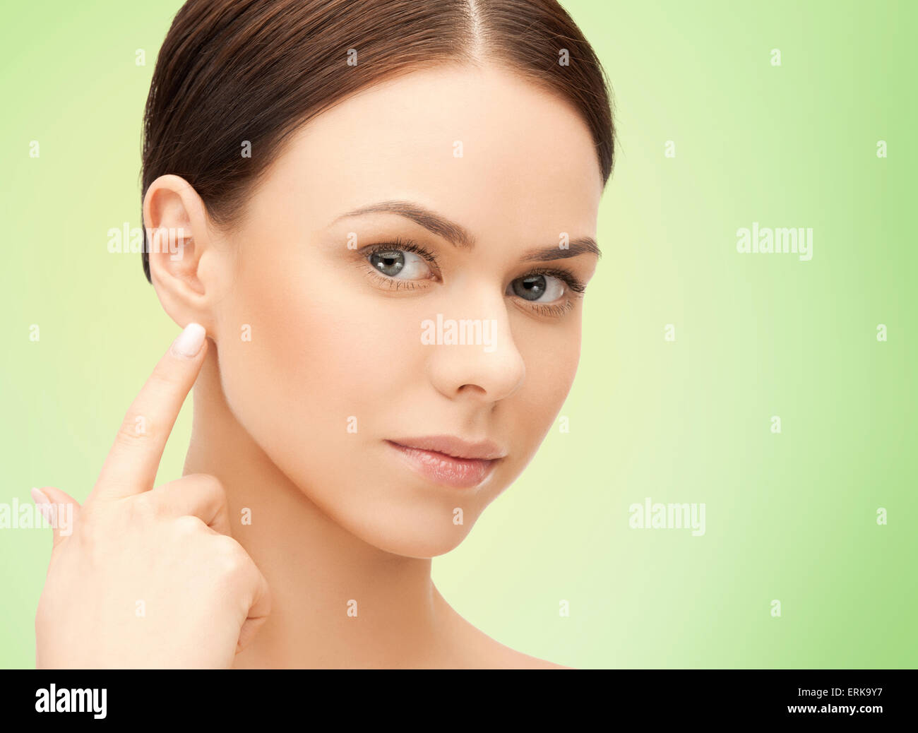face of beautiful woman touching her ear Stock Photo - Alamy