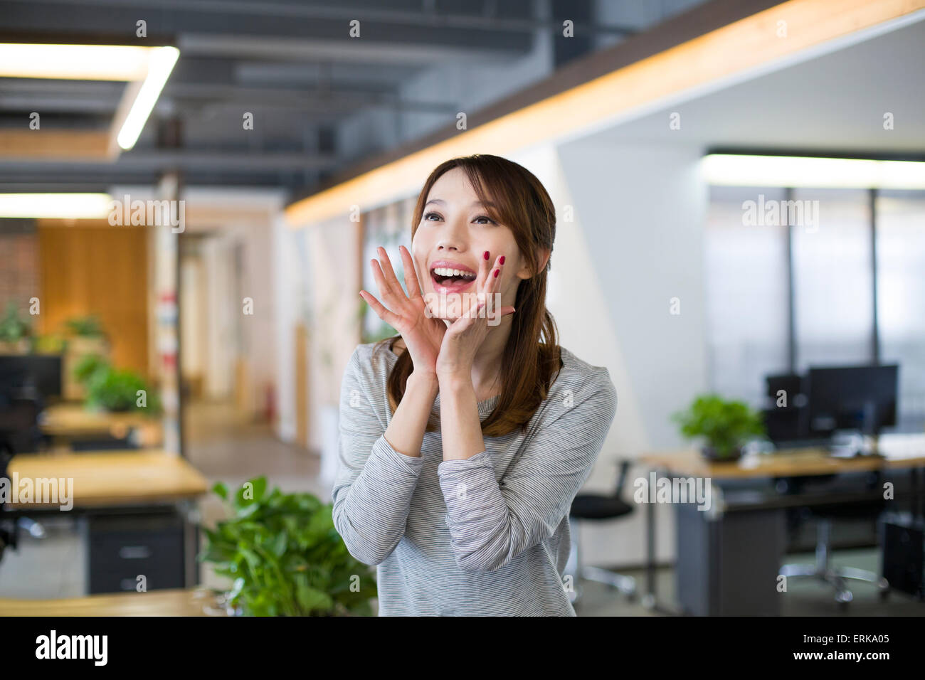 Young woman shouting in office Stock Photo - Alamy