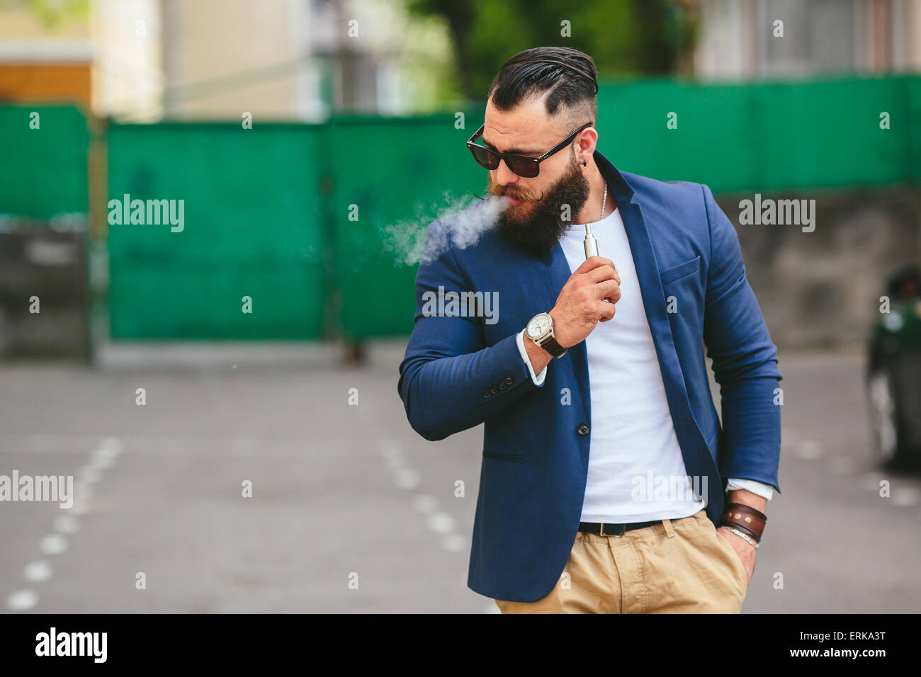 well-dressed man smoking electronic cigarette Stock Photo - Alamy