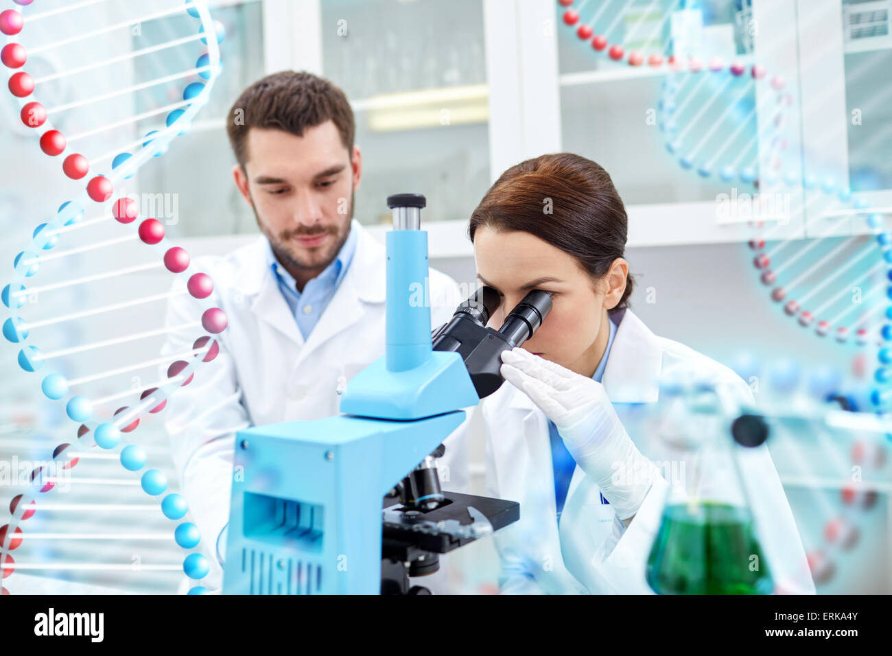 scientists with microscope making test in lab Stock Photo - Alamy