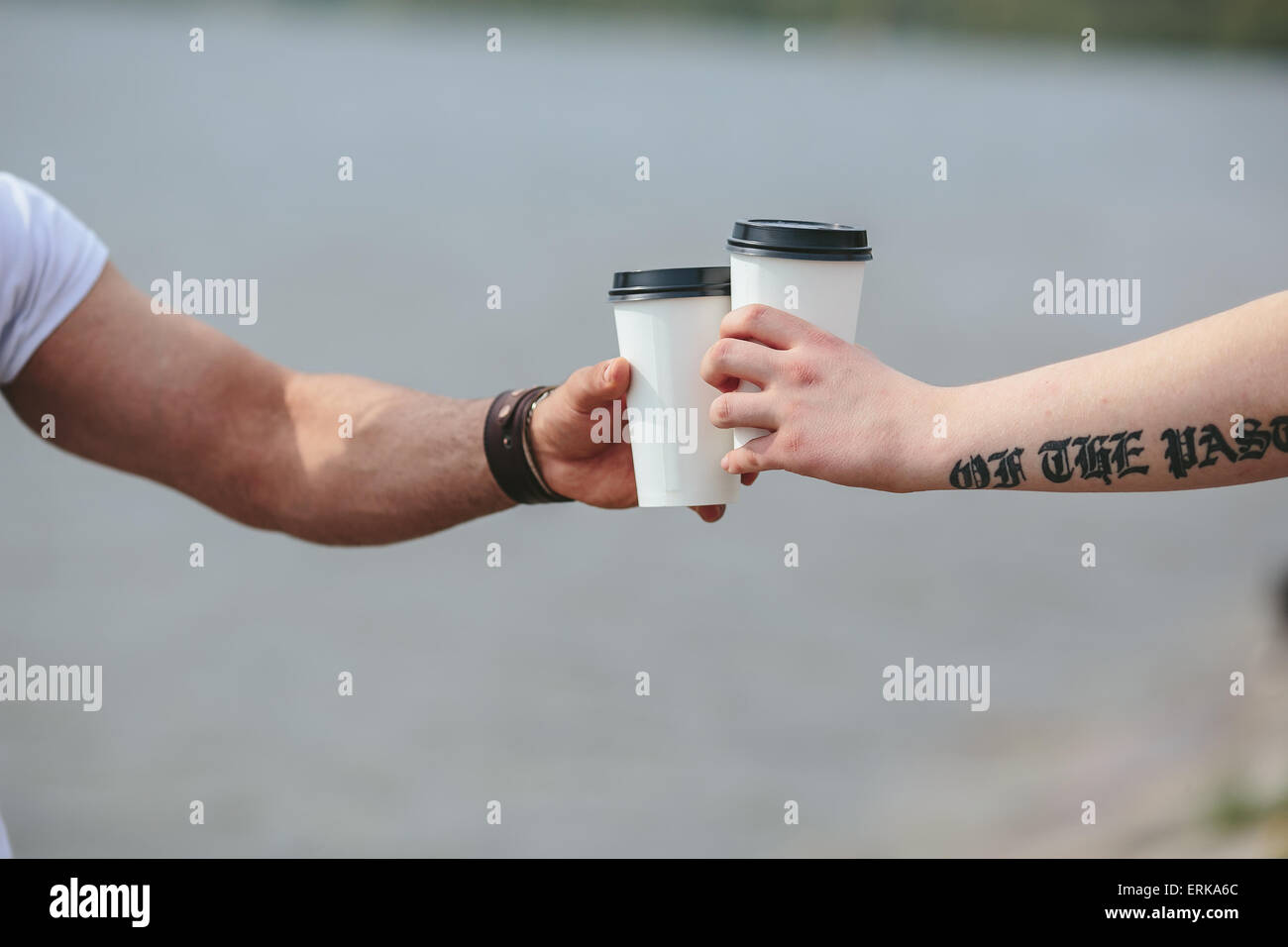 cheers using two cups of coffee Stock Photo - Alamy