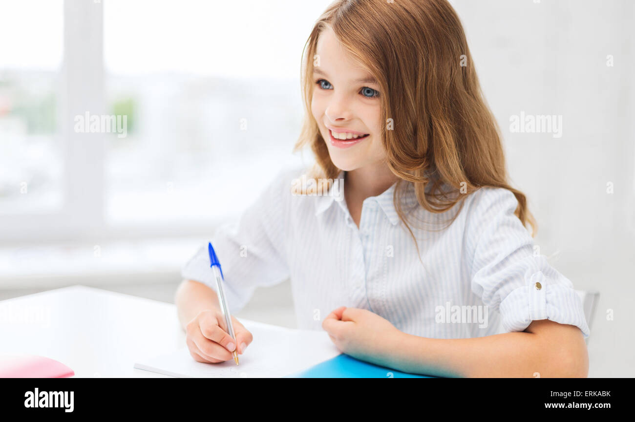 student girl writing in notebook at school Stock Photo - Alamy