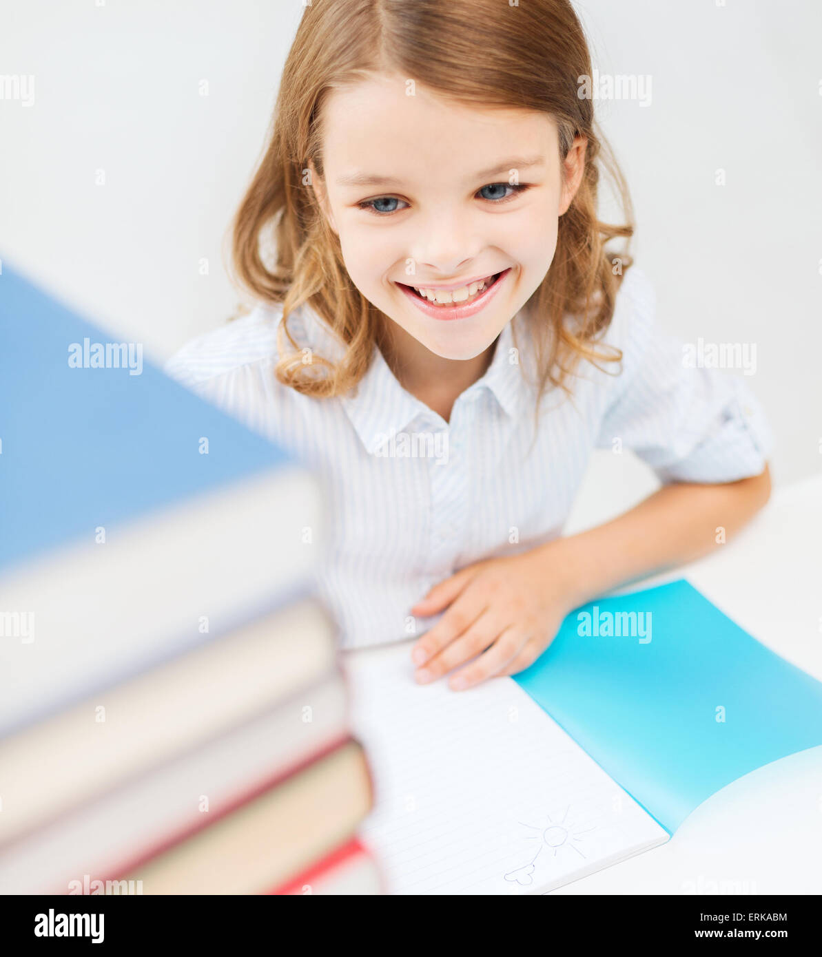 smiling little student girl with many books Stock Photo - Alamy