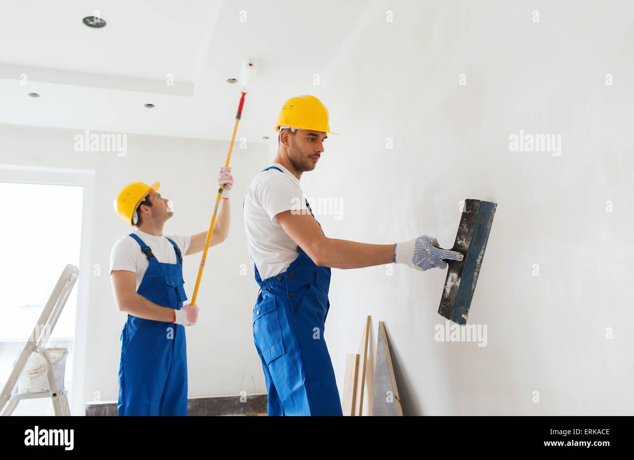 group of builders with tools indoors Stock Photo - Alamy