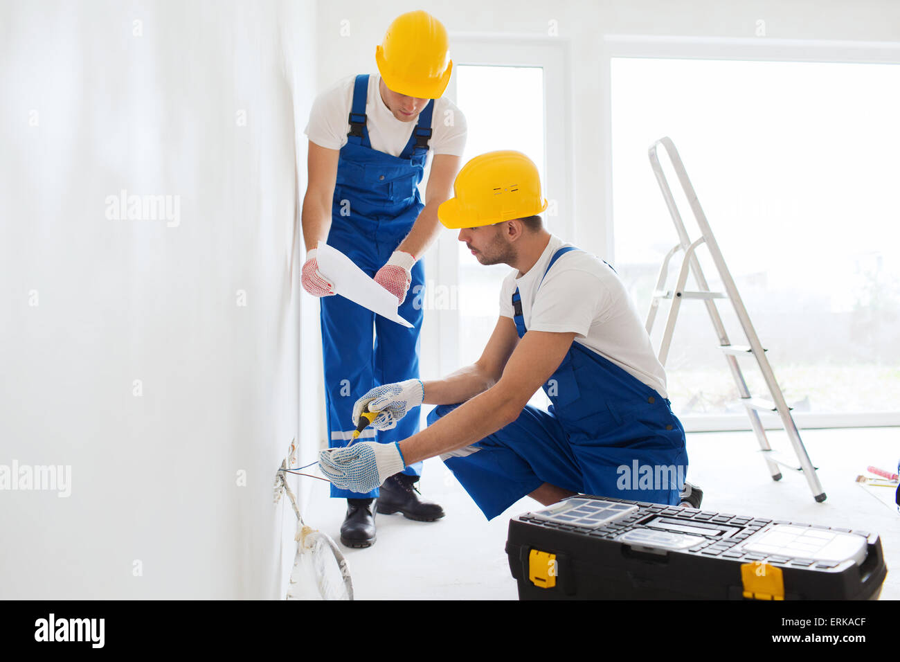 builders with tablet pc and equipment indoors Stock Photo - Alamy