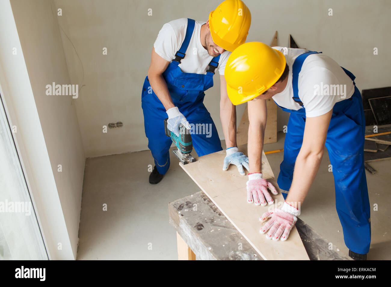 group of builders with tools indoors Stock Photo - Alamy