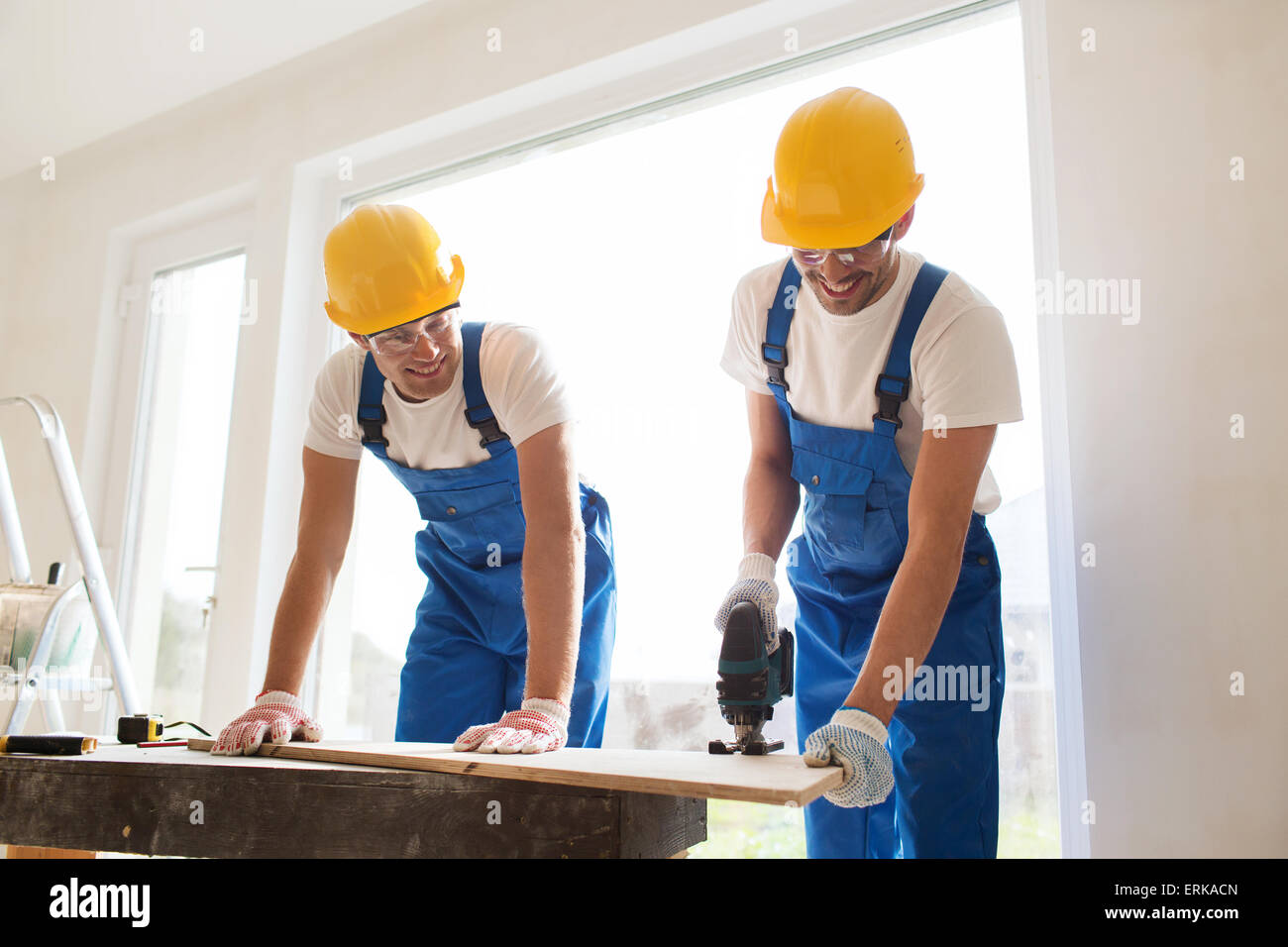 group of builders with tools indoors Stock Photo - Alamy