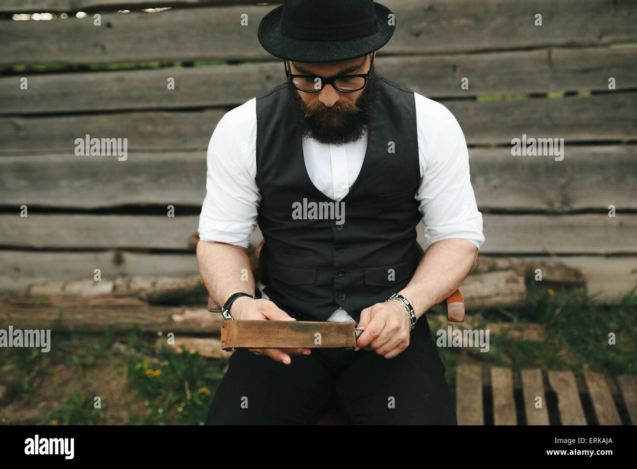strong man sharpens old razor Stock Photo - Alamy