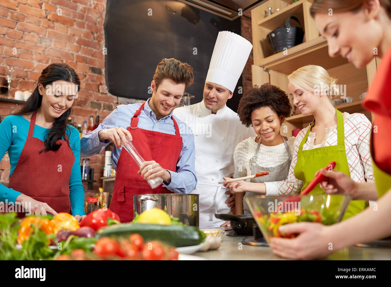 happy friends and chef cook cooking in kitchen Stock Photo - Alamy