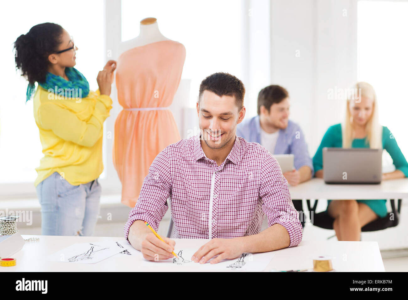 smiling fashion designers working in office Stock Photo - Alamy