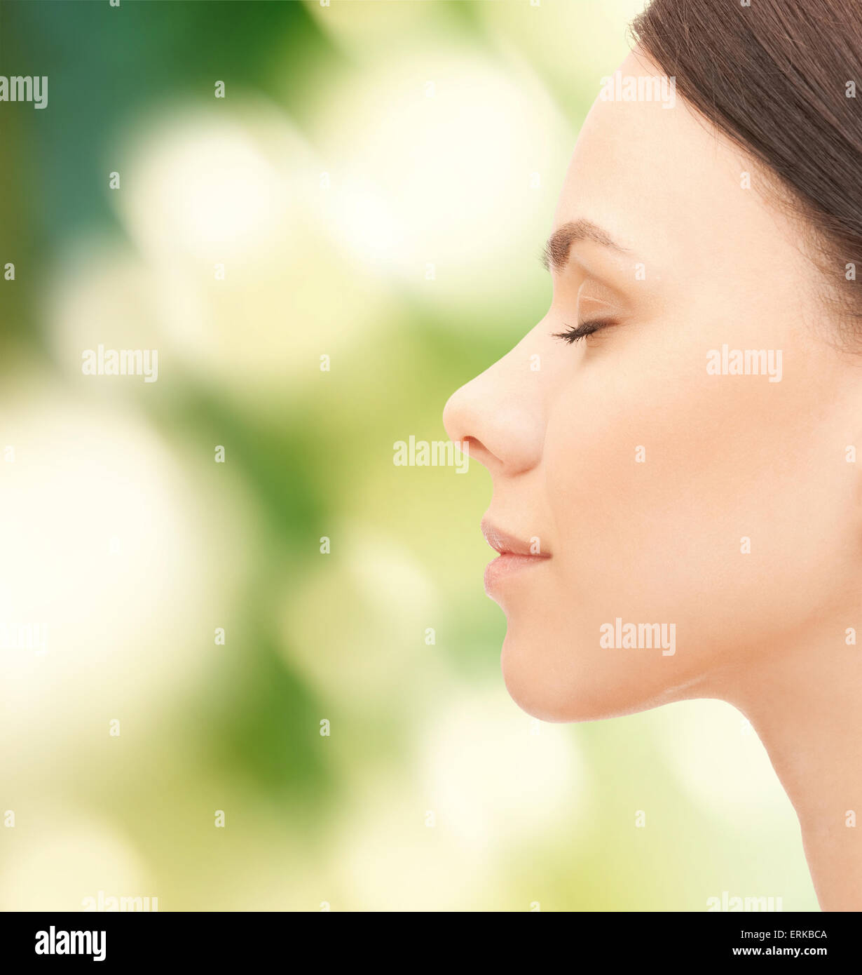 beautiful young woman face over green background Stock Photo - Alamy