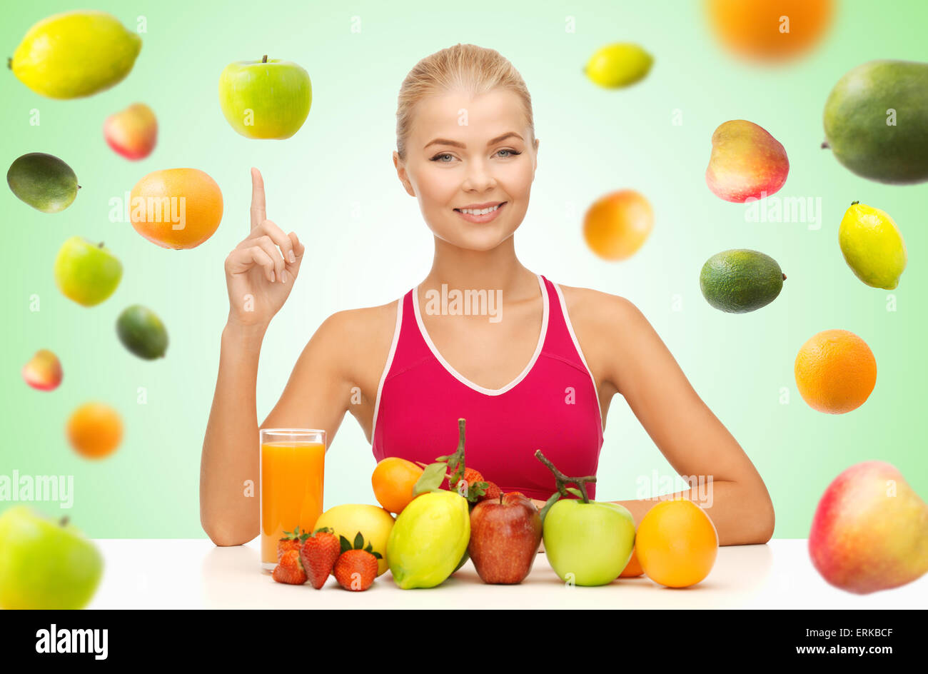 woman with juice and fruits pointing finger up Stock Photo - Alamy