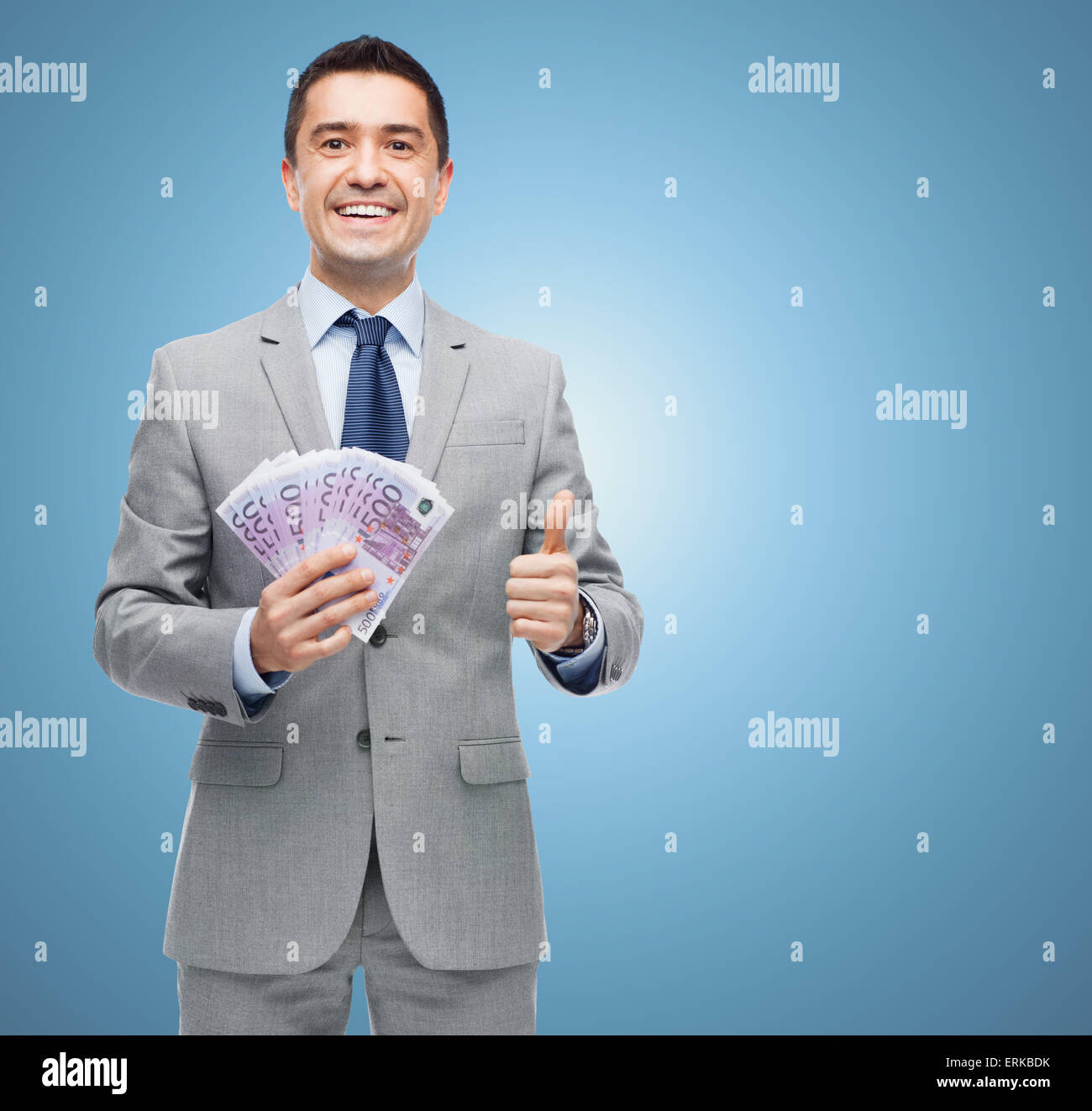 smiling businessman with money showing thumbs up Stock Photo - Alamy