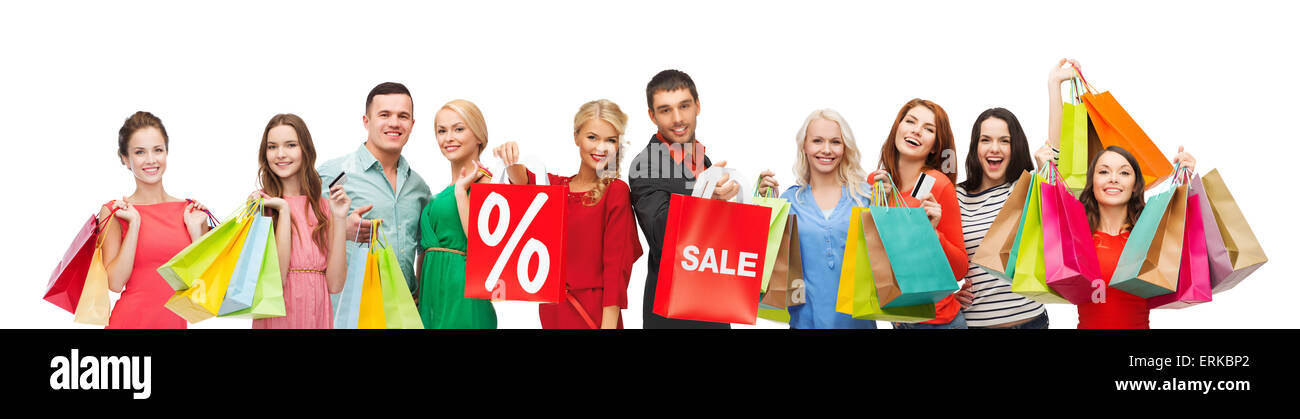 happy people with sale sign on shopping bags Stock Photo - Alamy