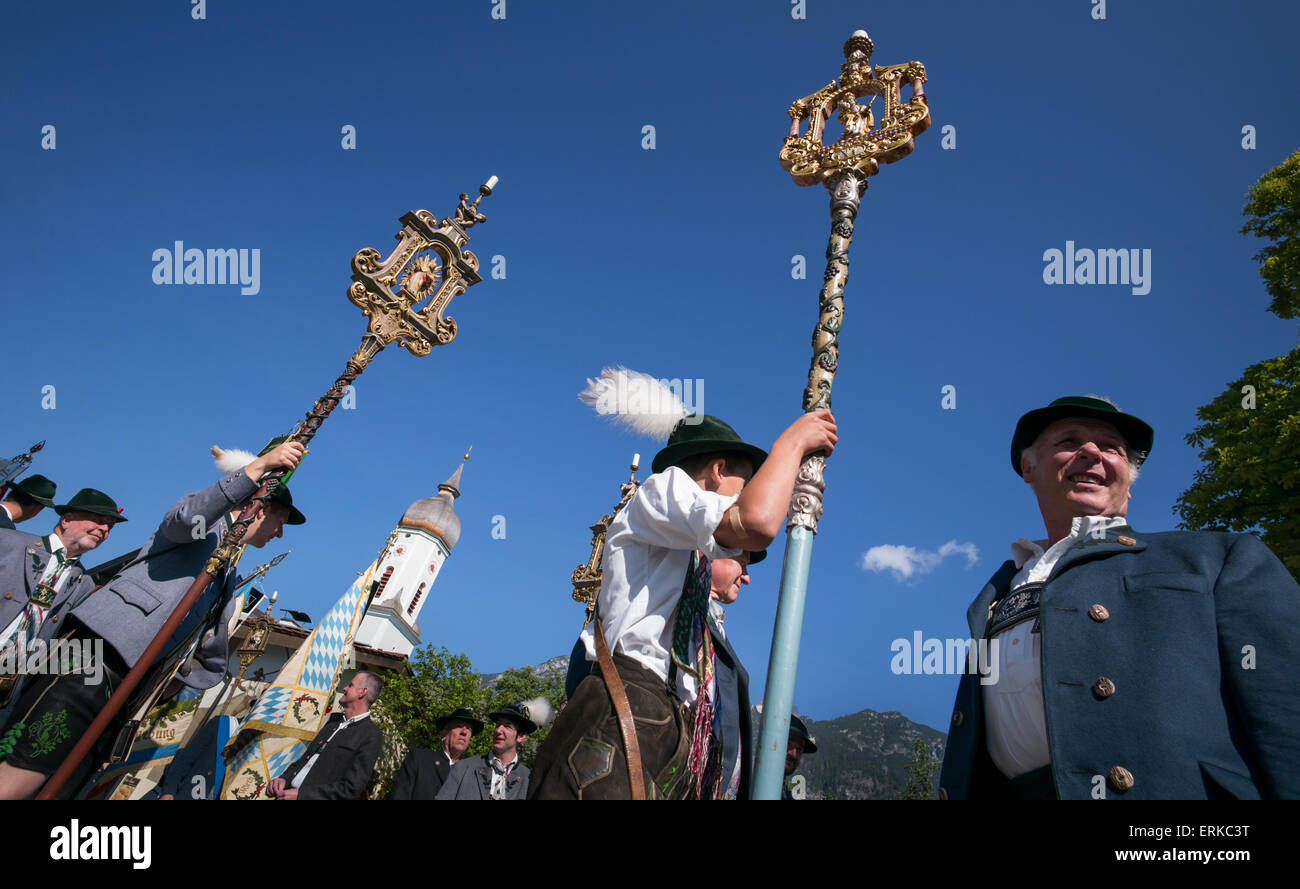 Catholics in traditional costume carry colorful flags and decorated ...