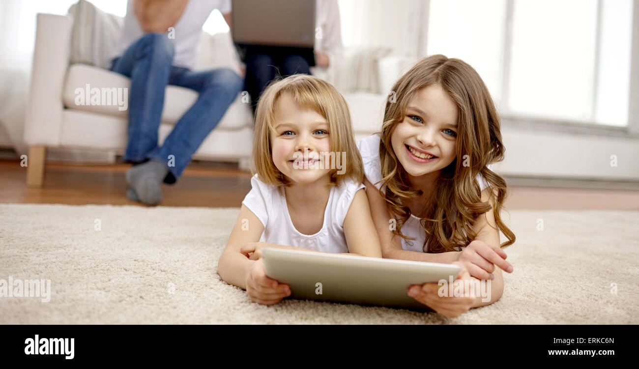 happy little girls with tablet pc computer at home Stock Photo - Alamy