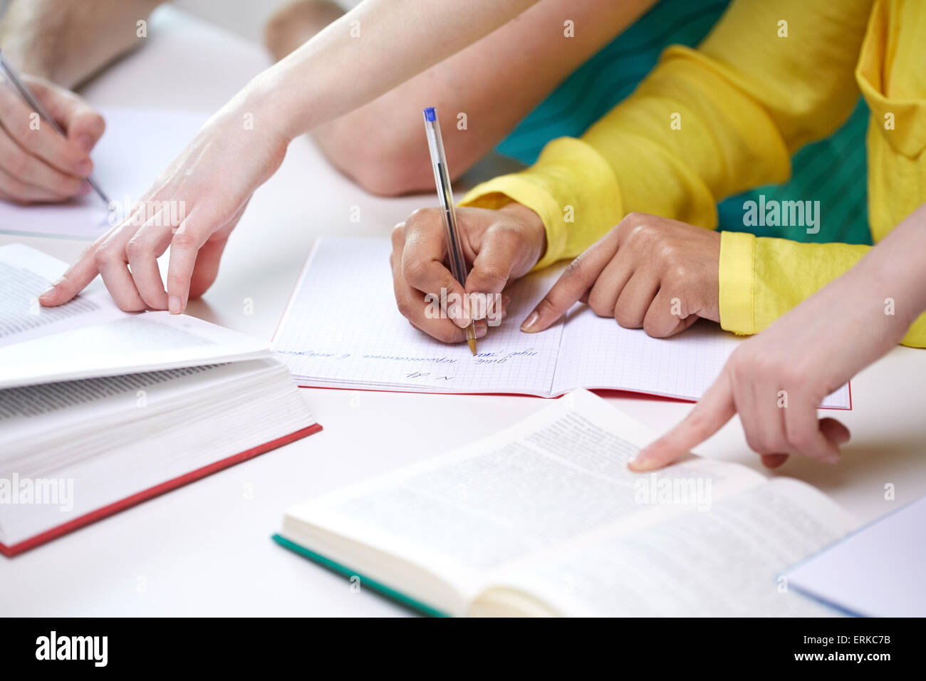 close up of students hands writing to notebooks Stock Photo - Alamy
