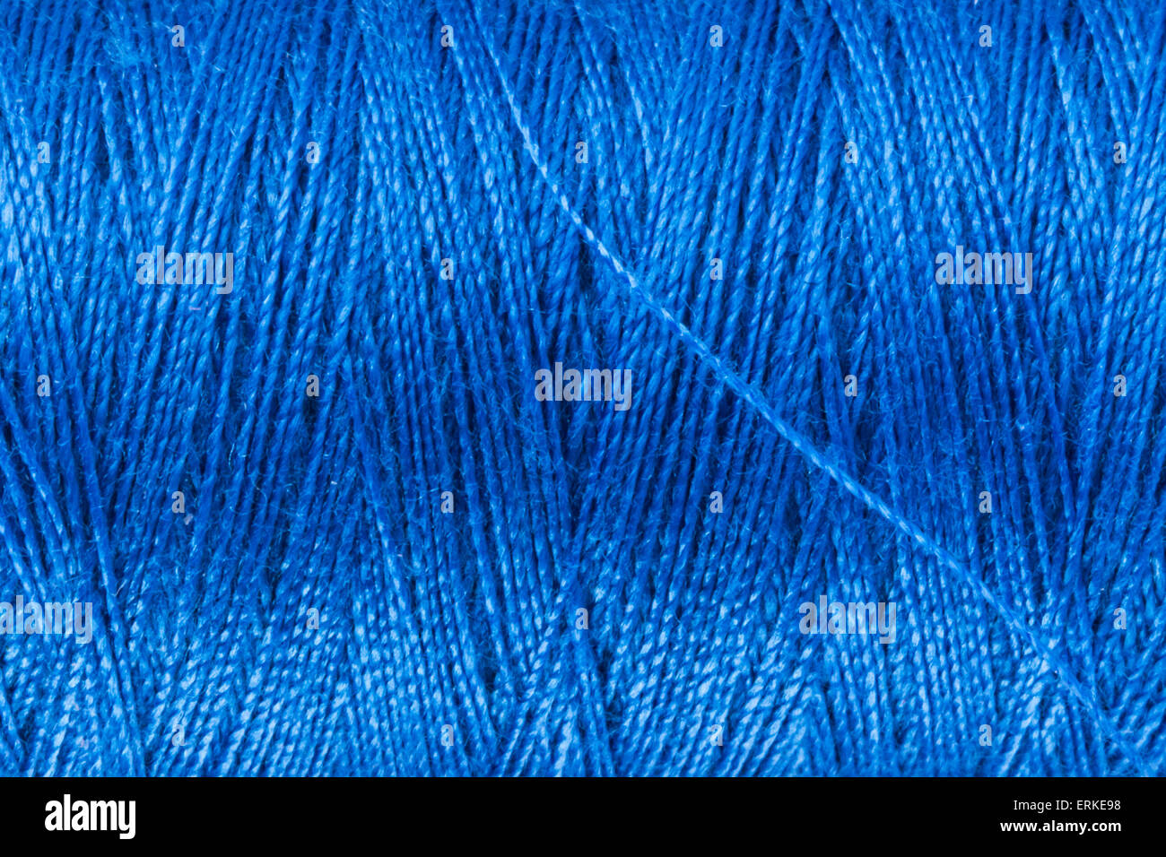 Background texture and macro view of blue sewing yarn Stock Photo - Alamy
