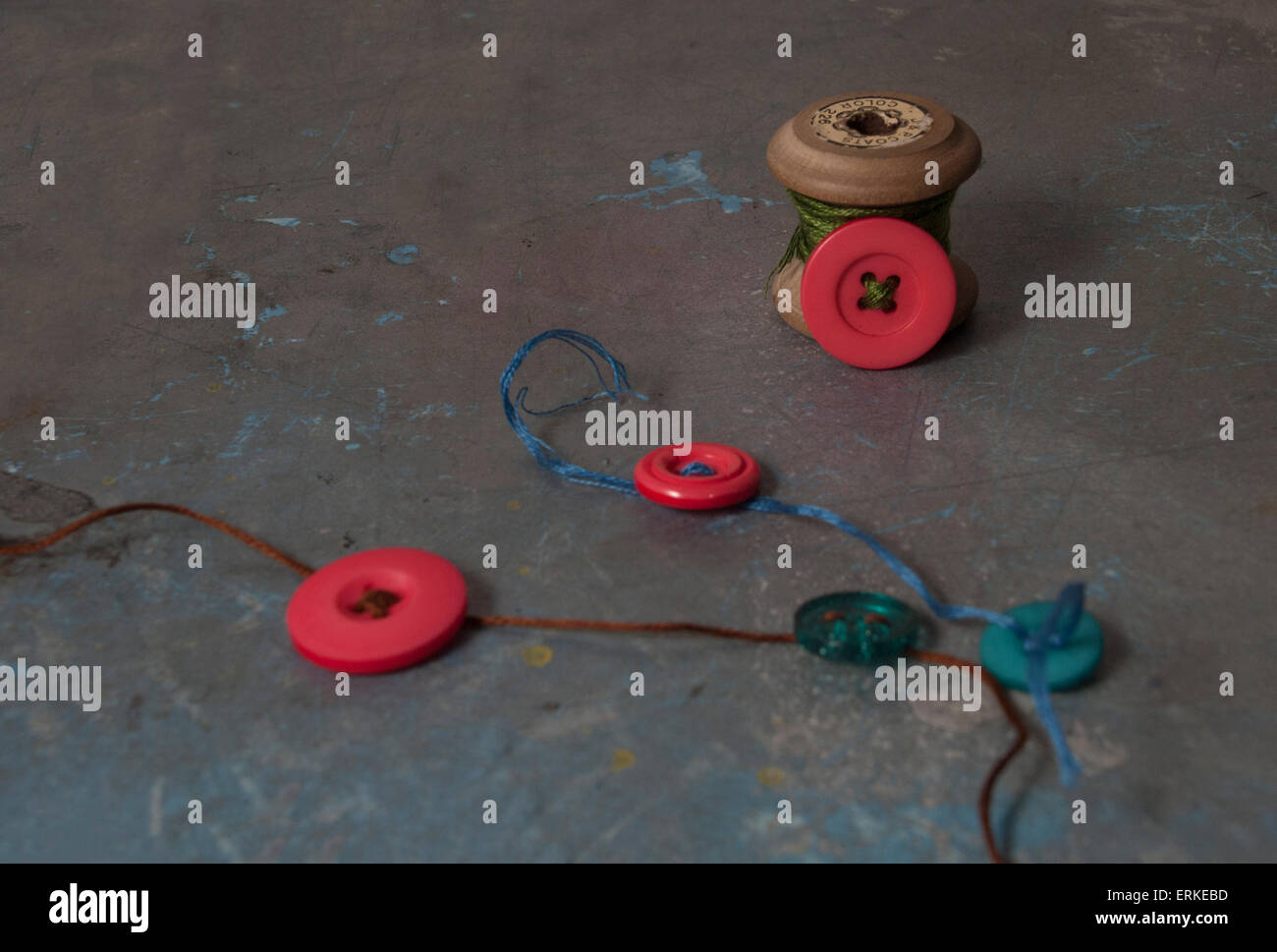 Different coloured thread with buttons Stock Photo - Alamy