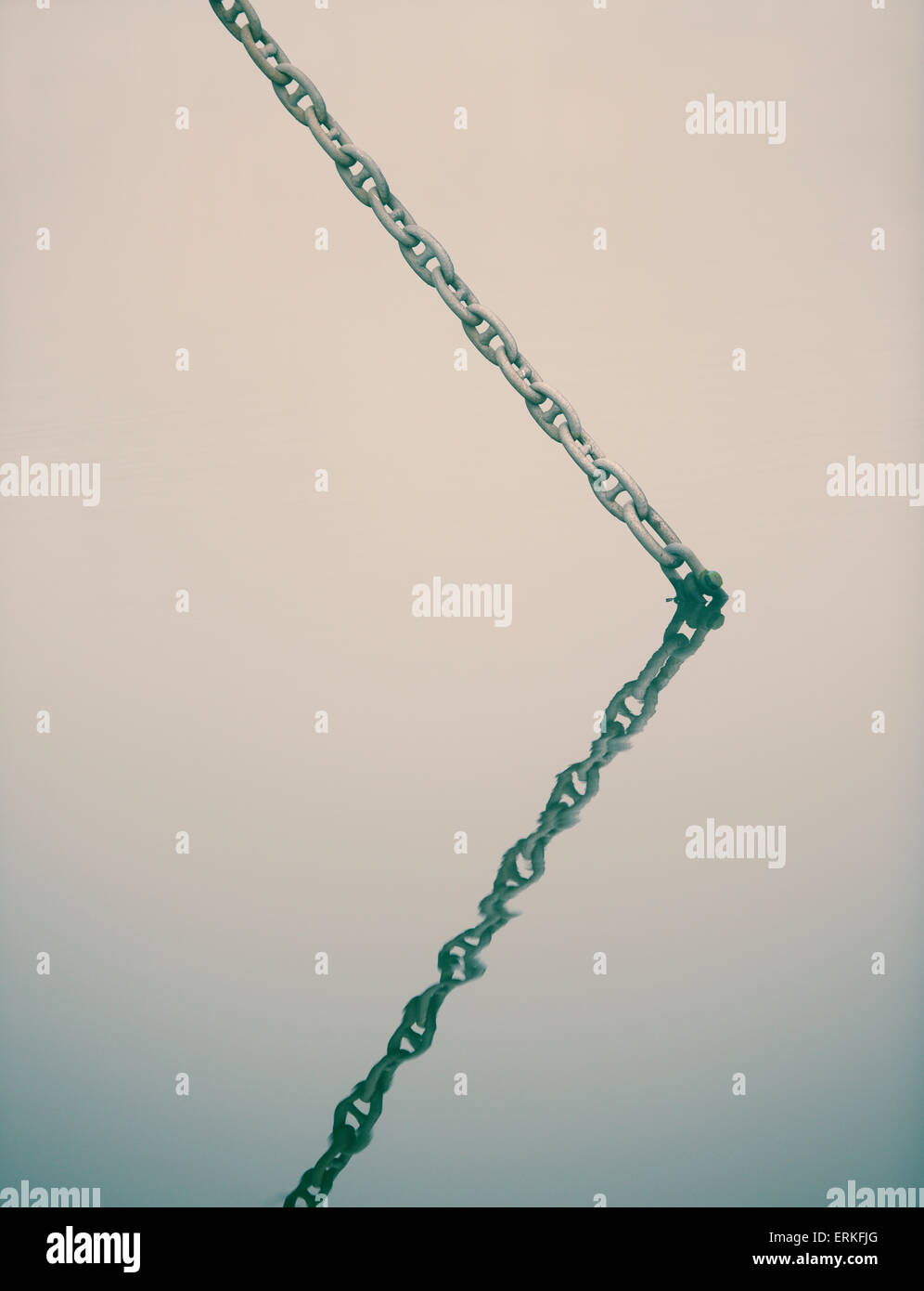 Tranquil water in heavy fog. Anchor chain of ship reflected on the ...