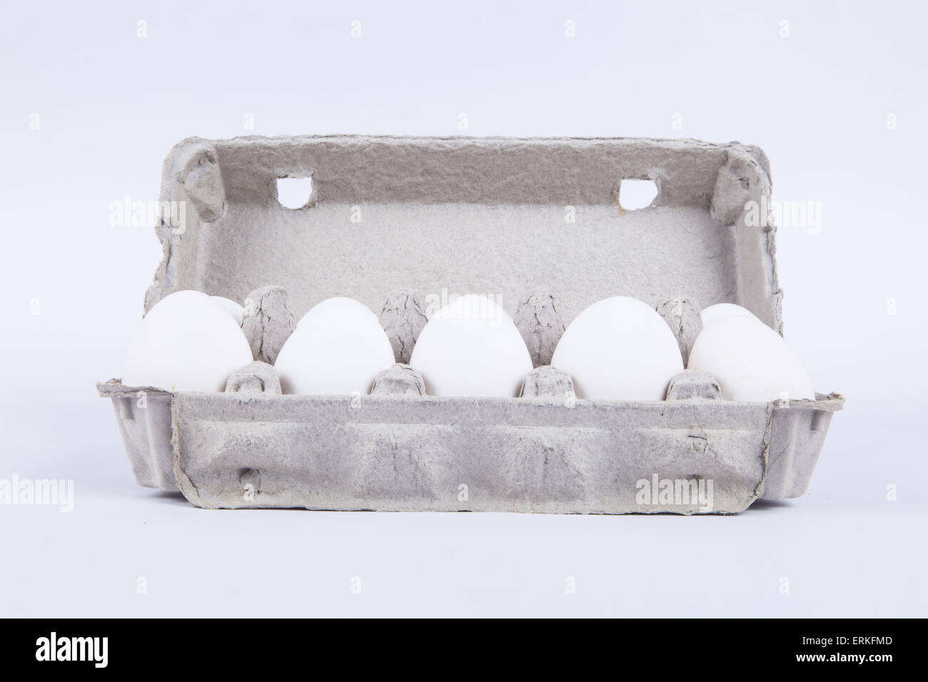 White eggs in carton with front view, isolated on white background ...