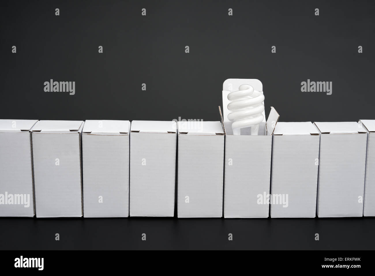 line of boxes with one open, an energy saving light bulb stands out ...