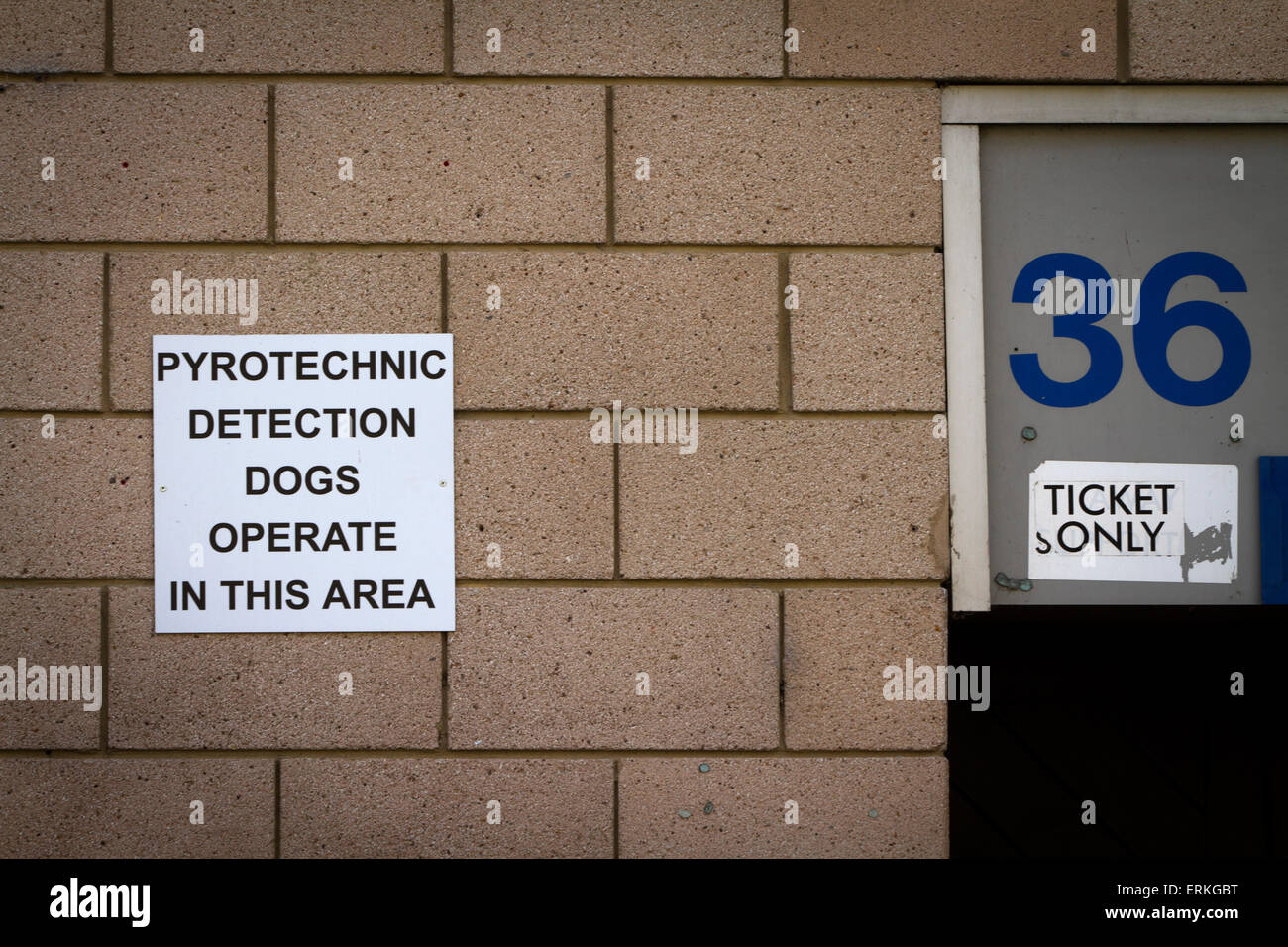 A warning sign about pyrotechnics next to a turnstile at the East Stand ...