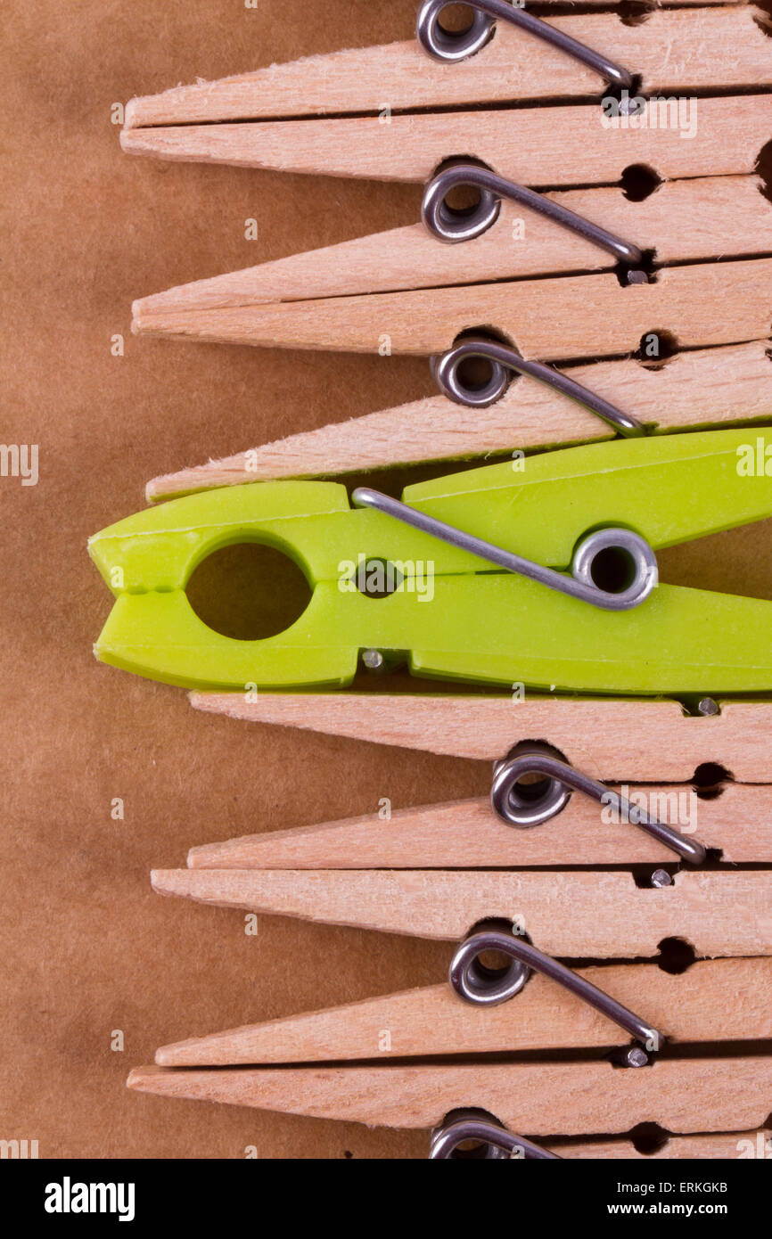 Detailed close up top view of wooden clothespins with a green one, on ...