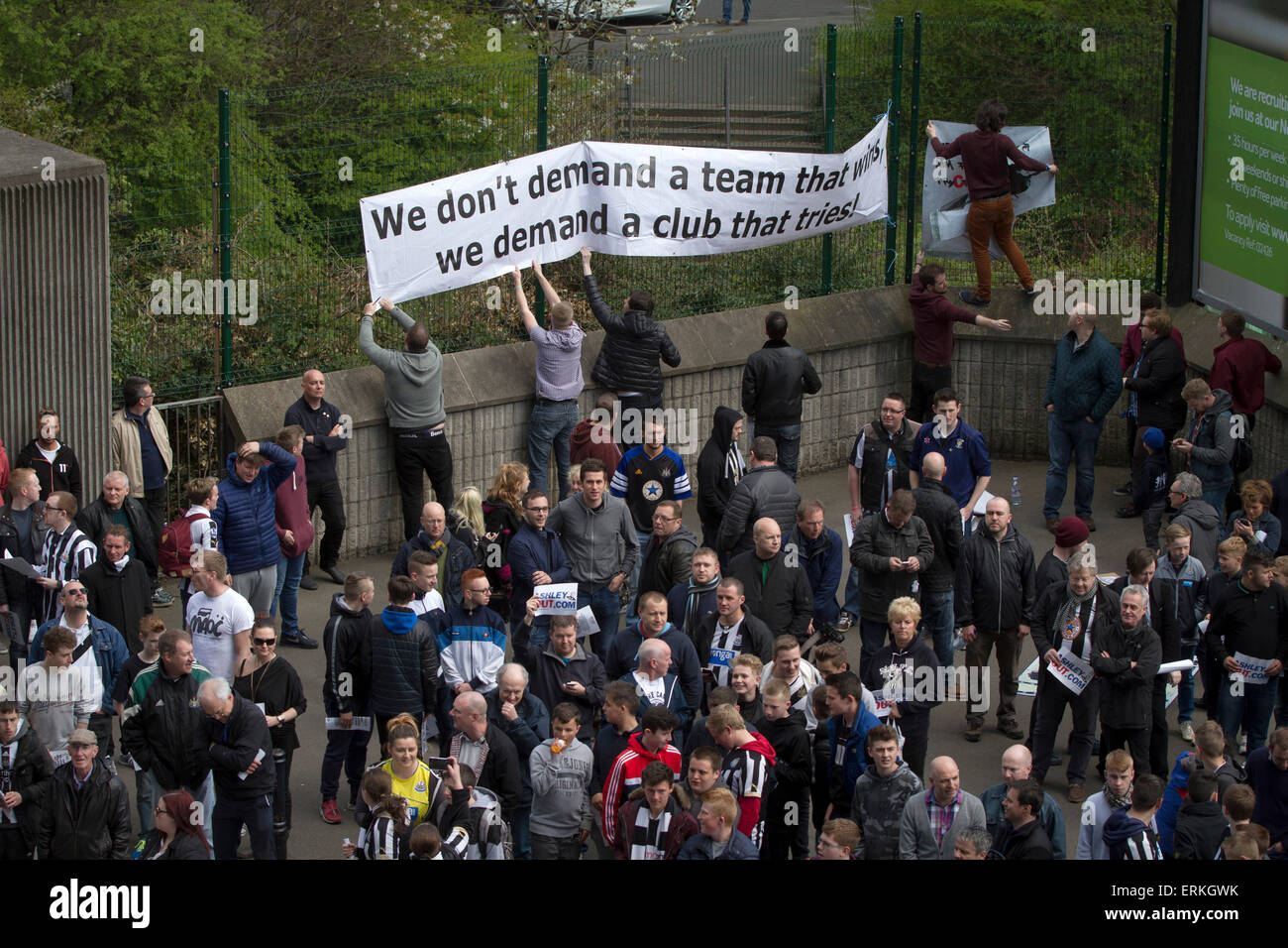 Protesters fixing a banner to a fence at the Gallowgate end of the ...