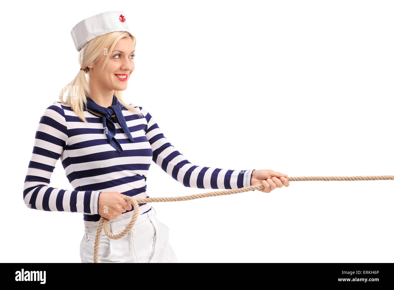 Cheerful female sailor pulling a rope and smiling isolated on white ...