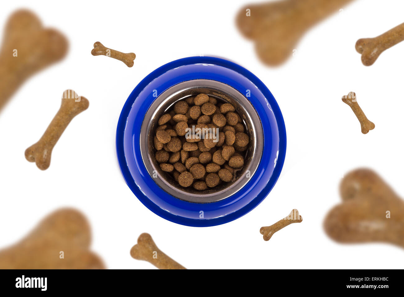 Top view of dog food treats falling, dropping down with blue feed bowl ...