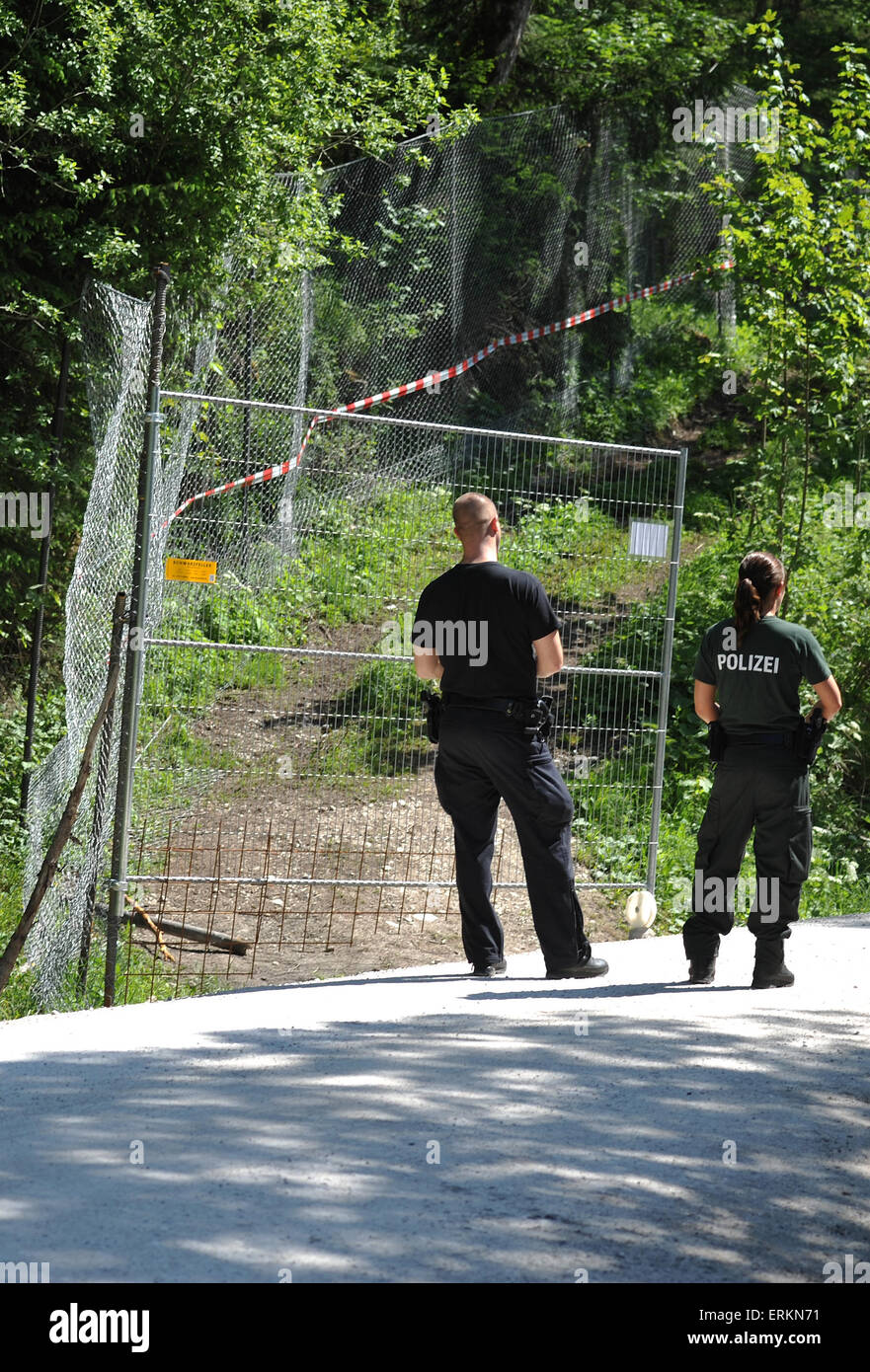 Two police officers supervise entry into the security zone around ...