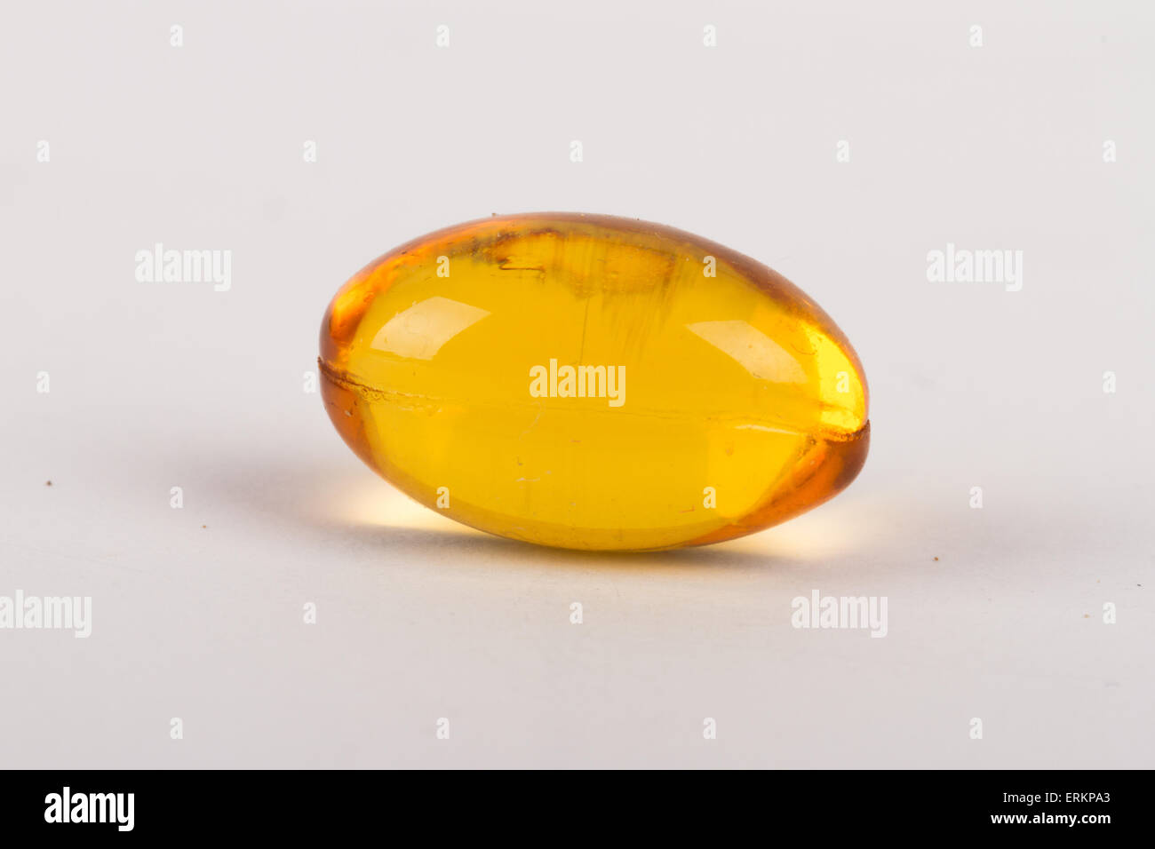 Detailed close-up yellow pill / vitamin with front view, isolated on ...