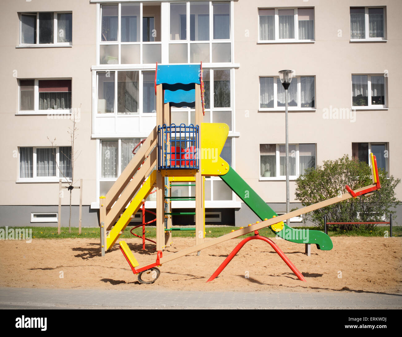 Colorful children playground in nature, front of row newly built block ...