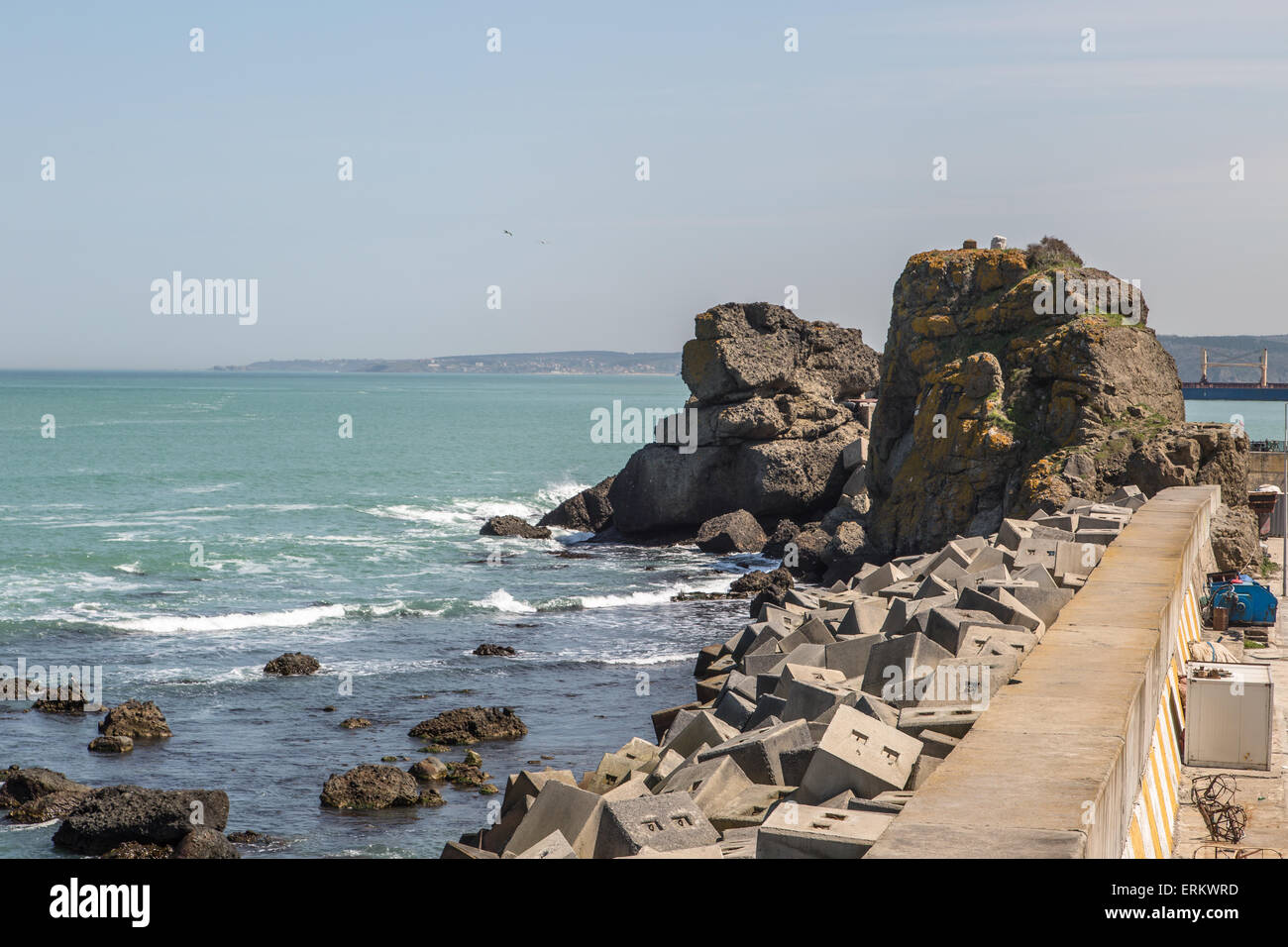 Close up front view of sea port with stones and rock by the seacoast in ...
