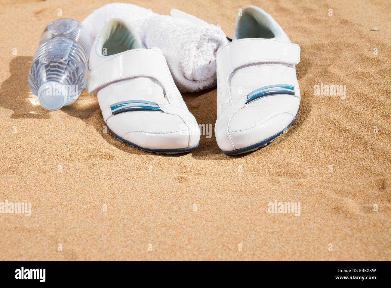 white sneakers in sand Stock Photo - Alamy