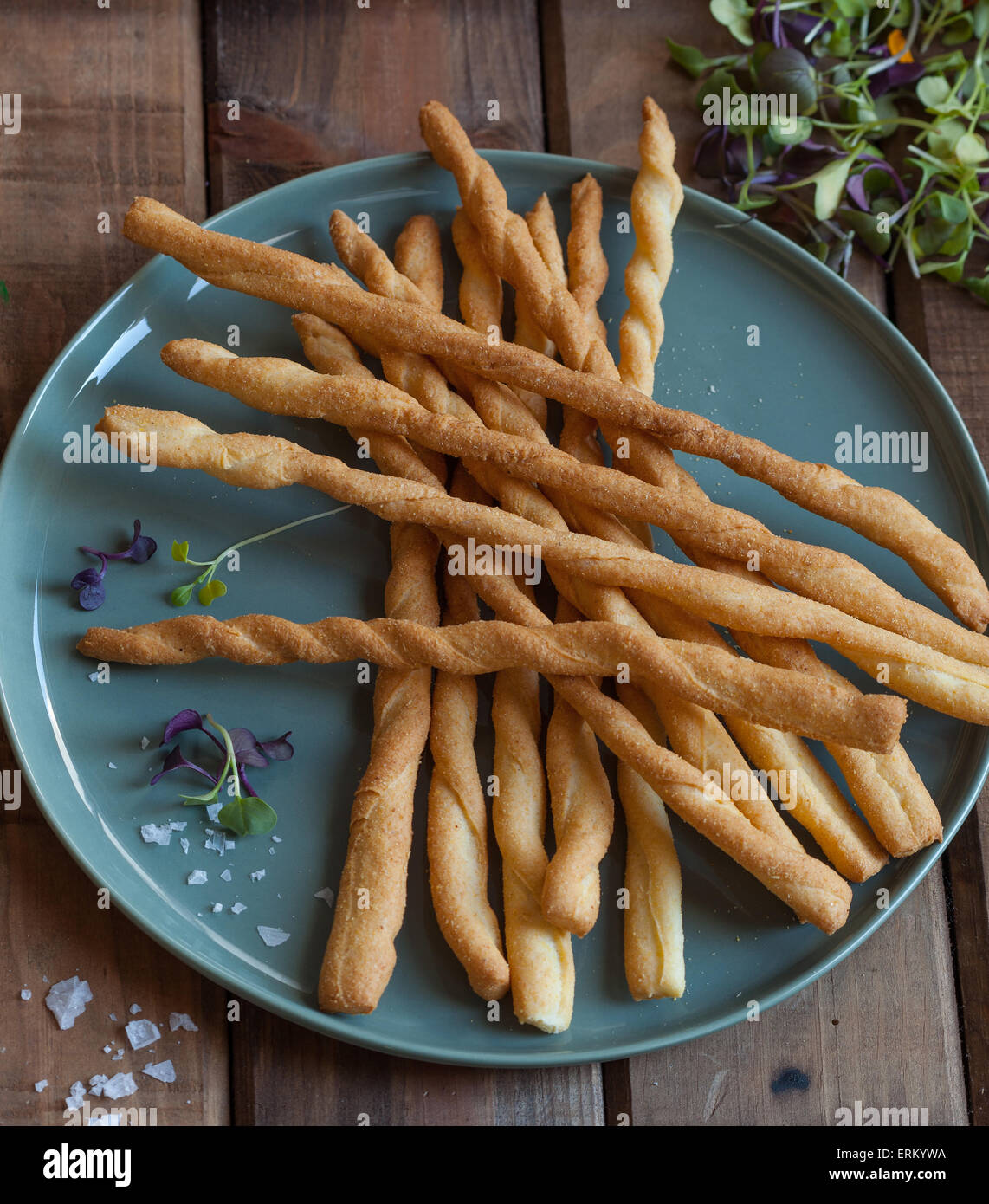 Italian breadsticks on a blue plate with herbs Stock Photo - Alamy