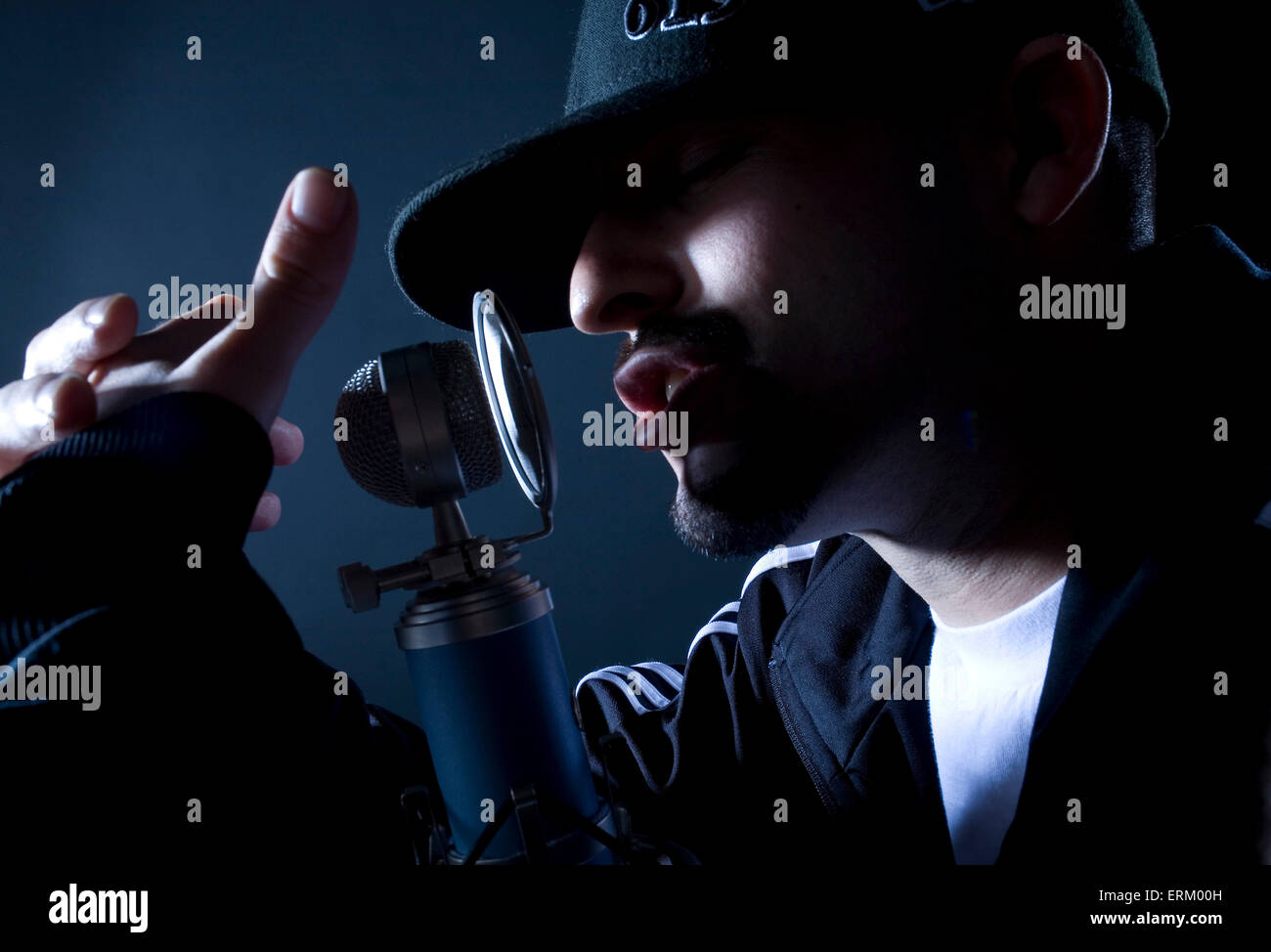 A rapper sings into a microphone in Chula Vista, California Stock Photo ...